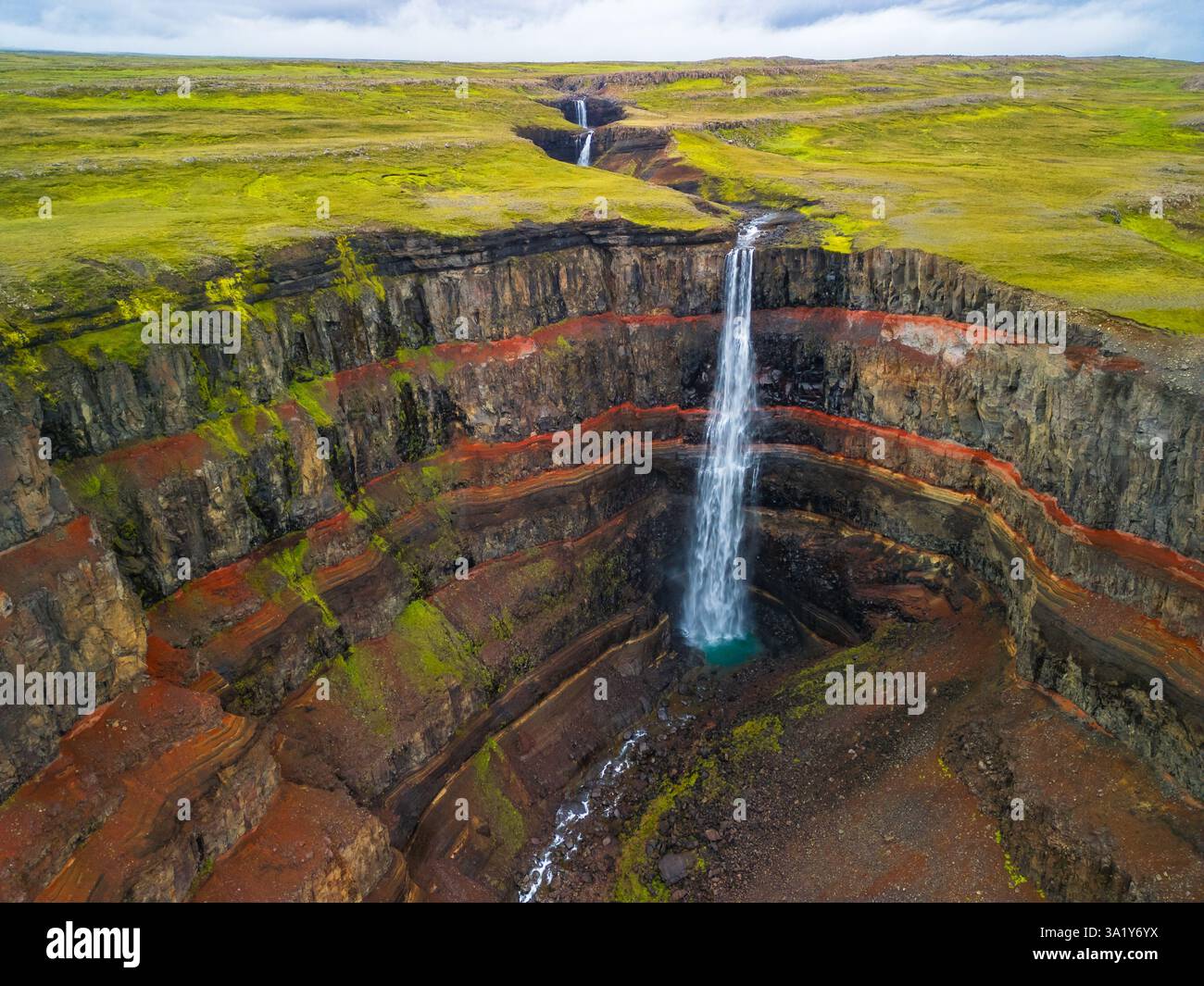 Aerial drone view of Hengifoss waterfall landscape in Iceland. Red ...