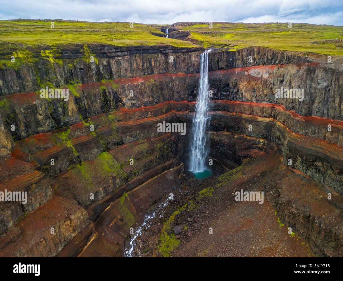Aerial drone view of Hengifoss waterfall landscape in Iceland. Red ...