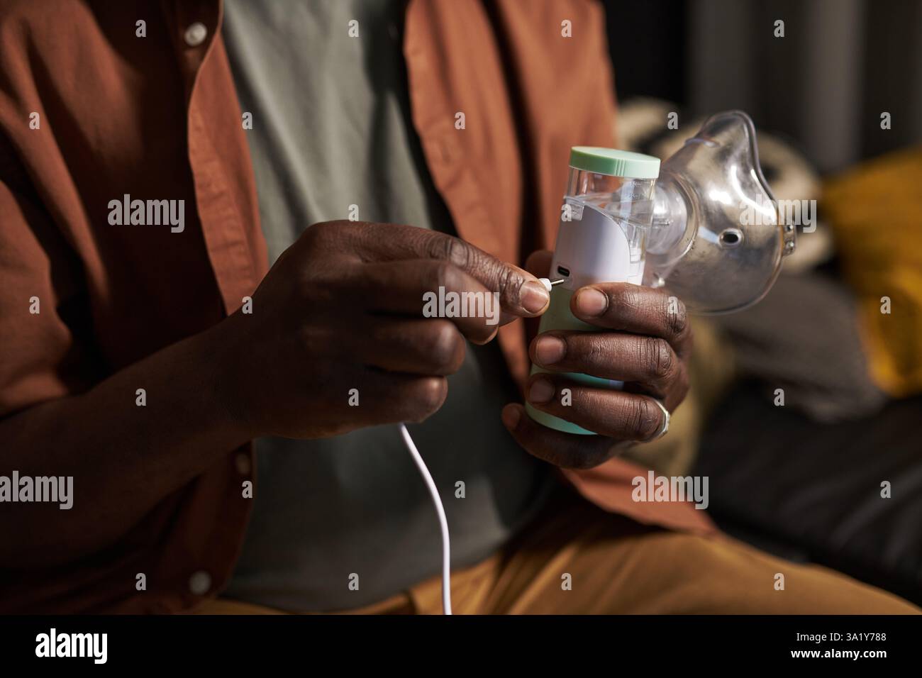 Hands of African American senior man switching inhaler before breathing ...