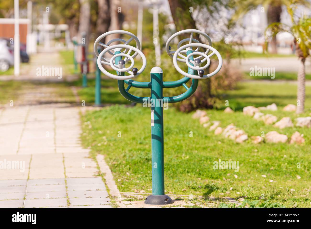Public exercise machine with rotating wheels designed Stock Photo - Alamy