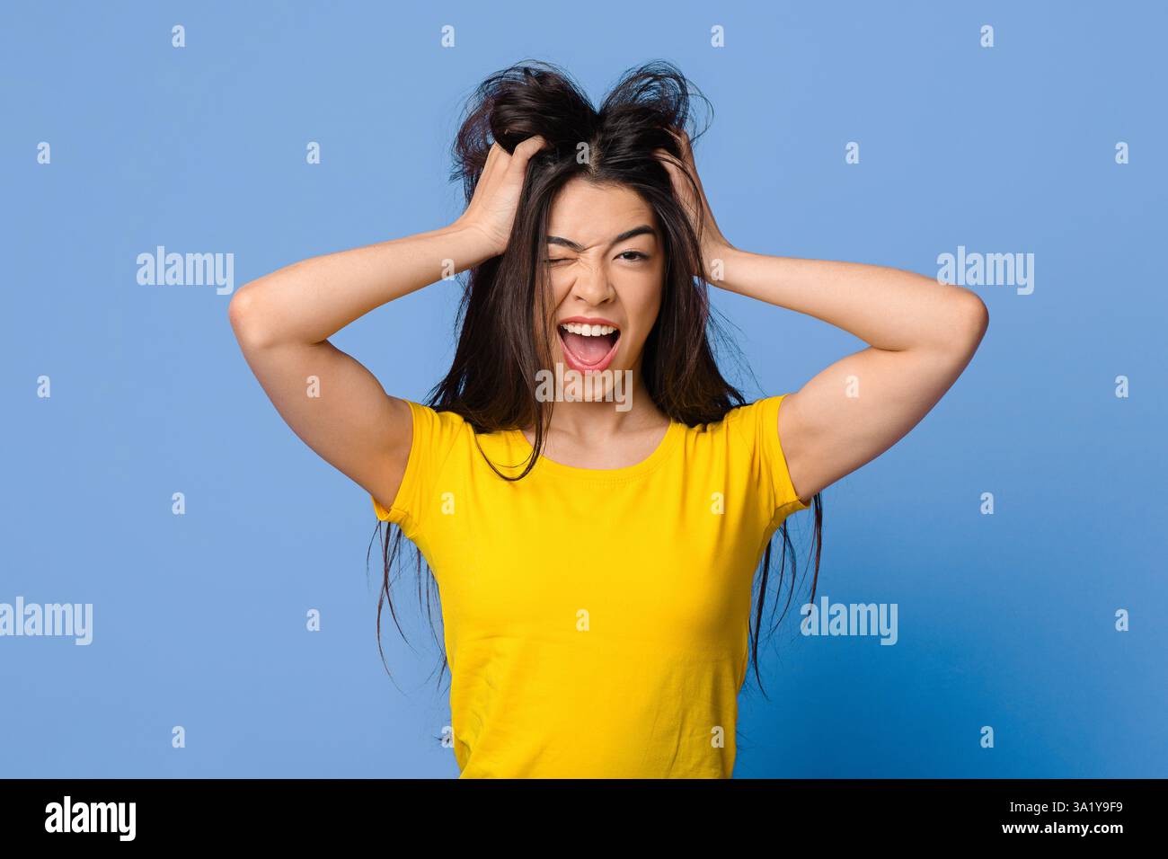 Mad Mood. Crazy Asian Woman Touching Tousled Hair And Winking At Camera ...