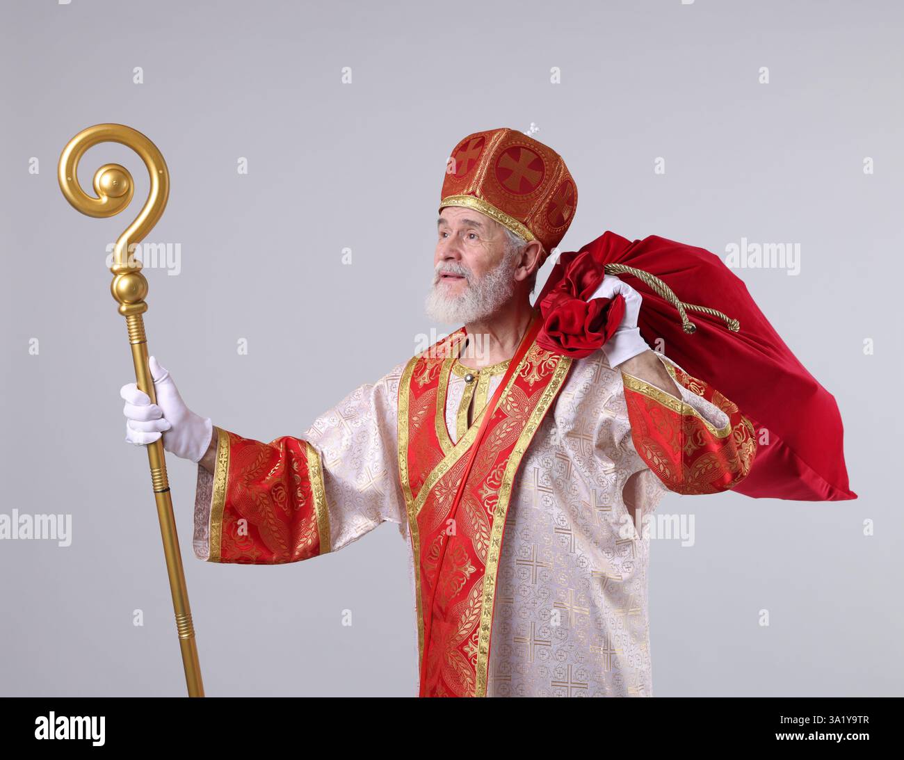 Saint Nicholas with sack on light grey background Stock Photo - Alamy