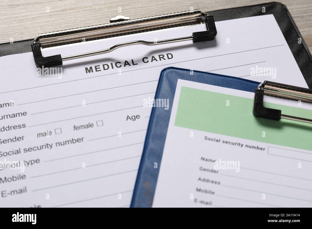 Medical card forms on light wooden background, closeup Stock Photo - Alamy