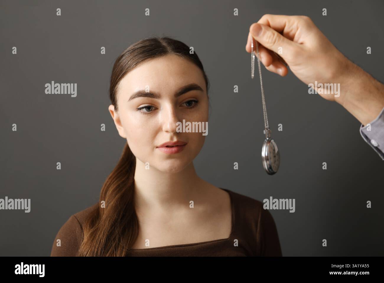 Psychologist using vintage pocket watch while working with patient ...