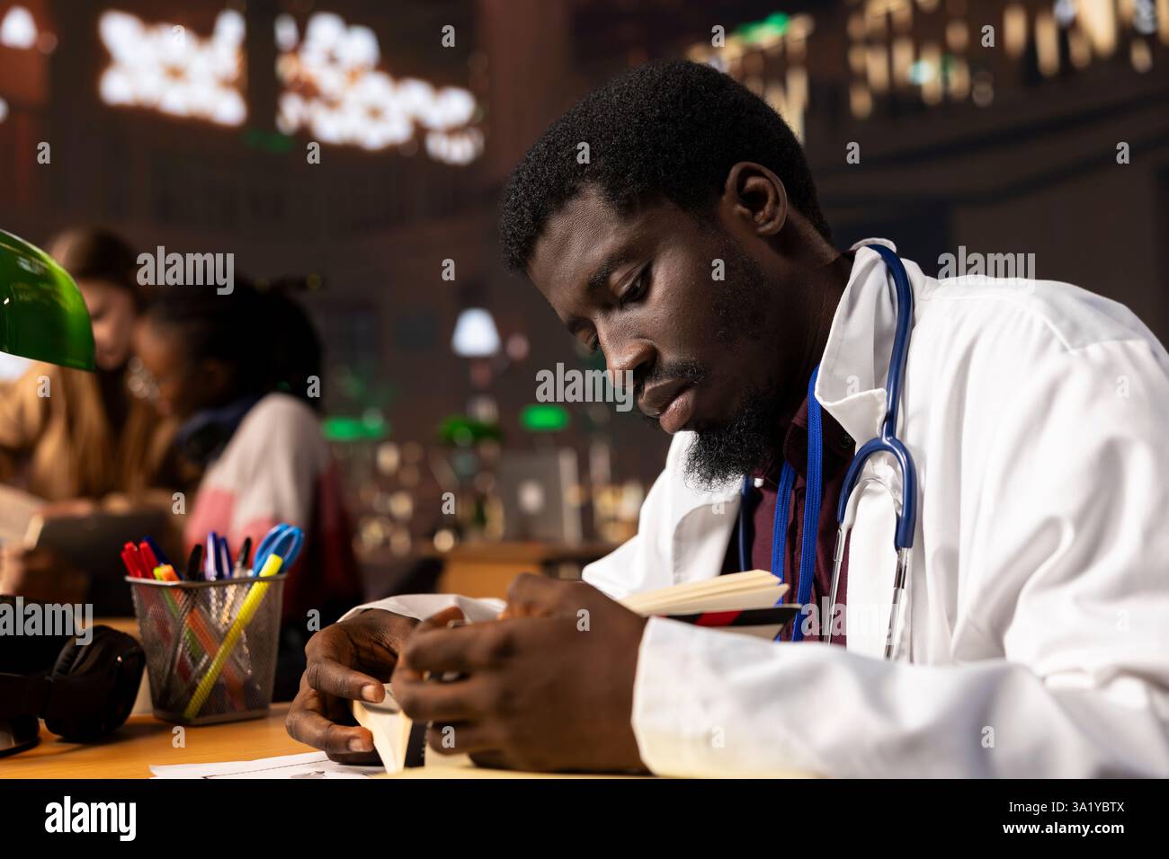 African american medical student learning for a residency exam ...