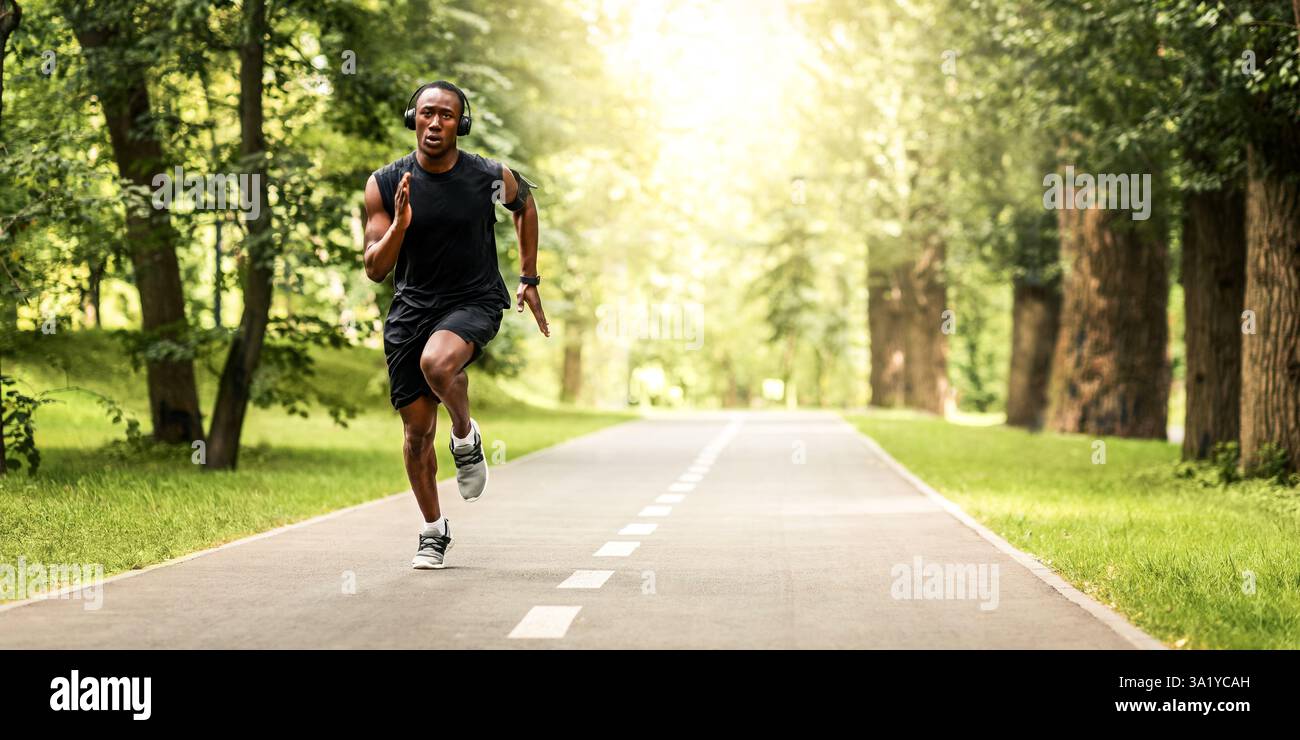 Concentrated sportsman running by park path in summer Stock Photo - Alamy