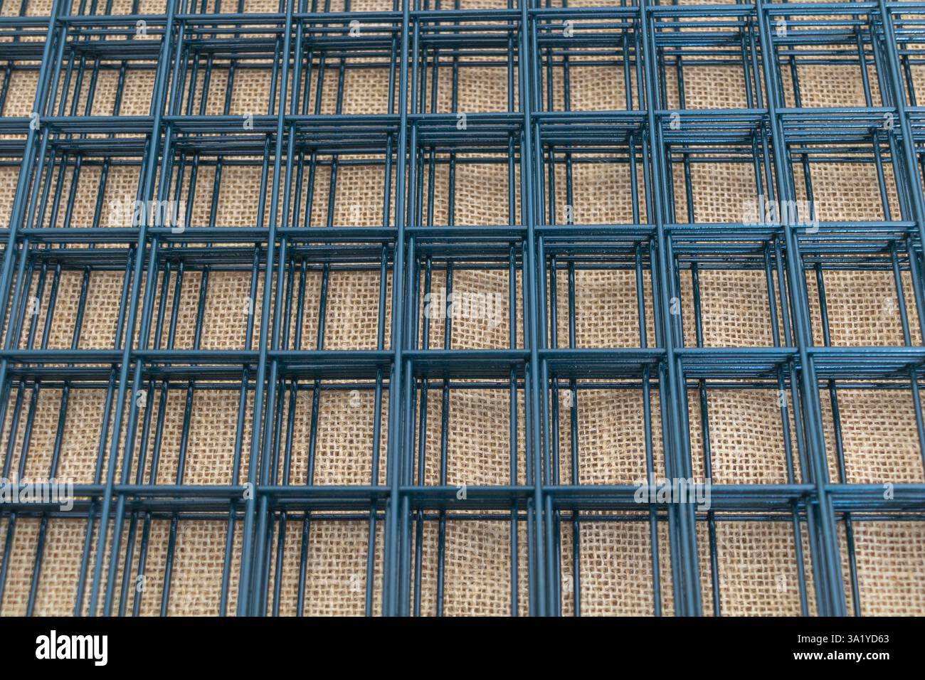 Blue wire mesh grid on a burlap background Stock Photo - Alamy