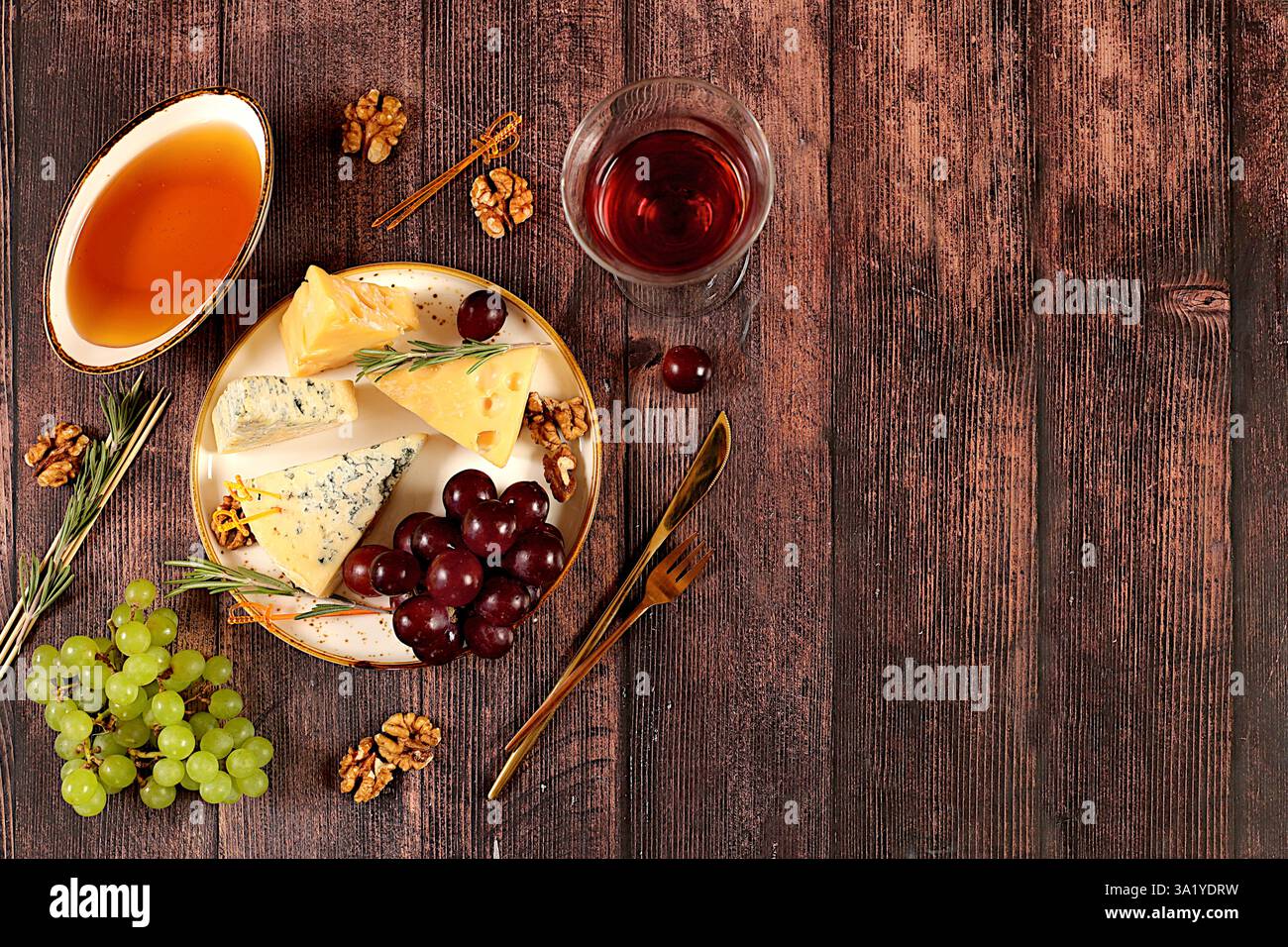 Still life with gourmet blue cheese, parmesan, grapes, honey, nuts ...