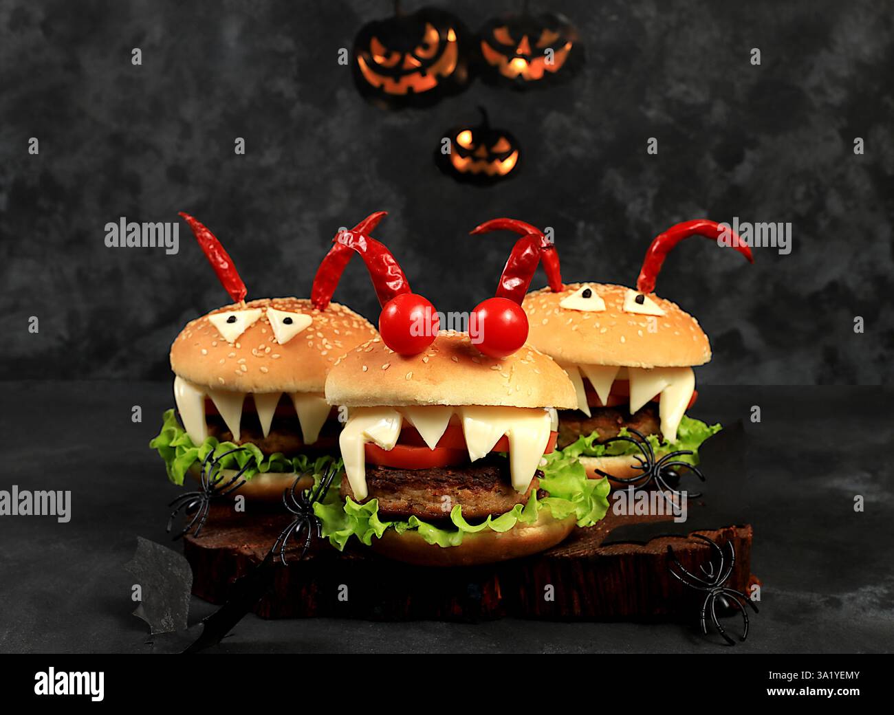 Halloween food concept. Scary hamburgers with fresh lettuce, tomatoes ...