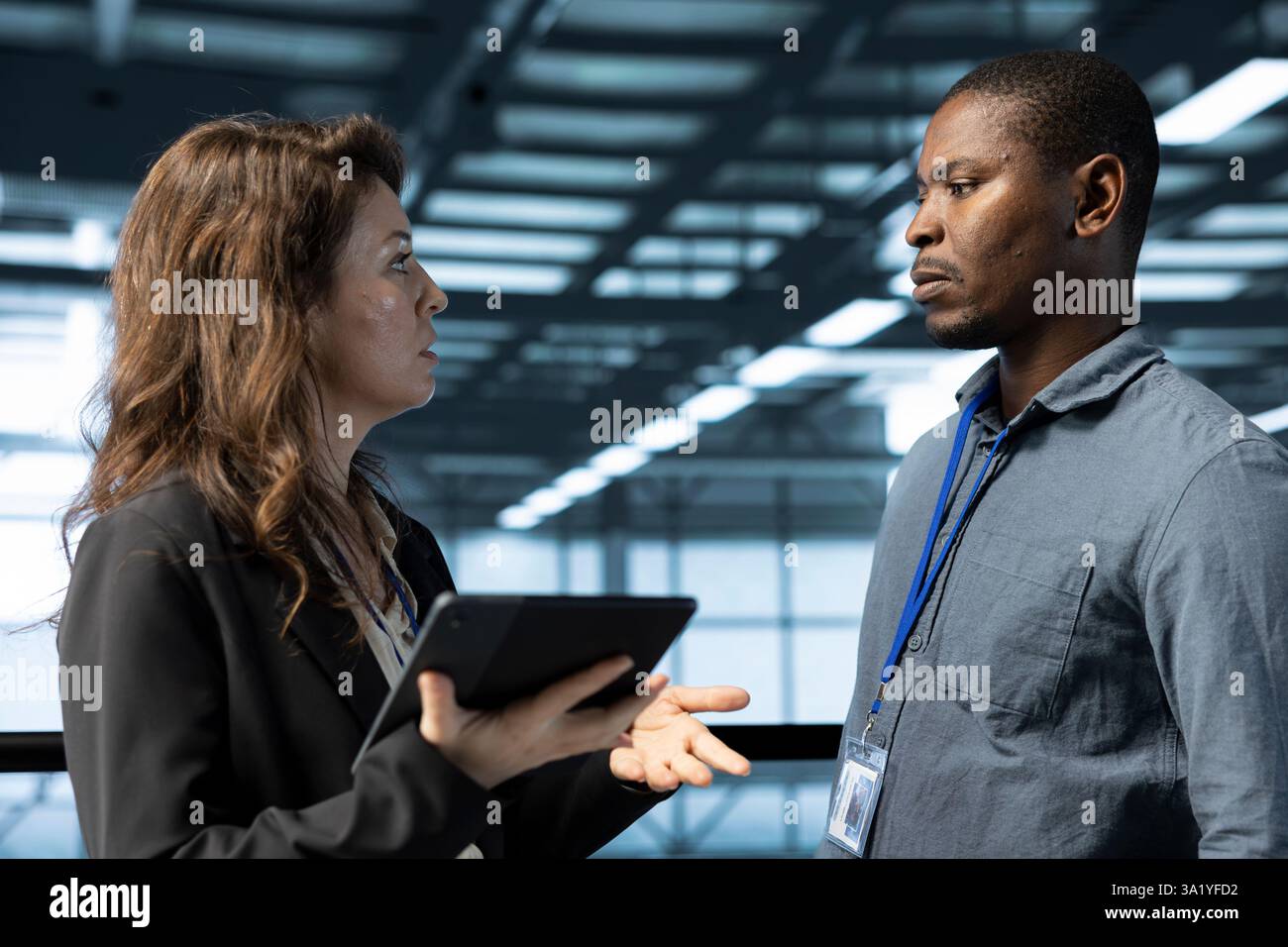 IT staff members in data center using tablet to develop disaster ...