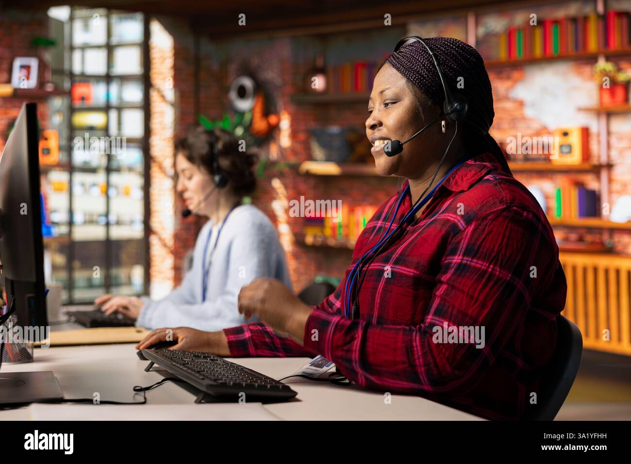 Happy call center worker analyzes customer feedback data, working to ...