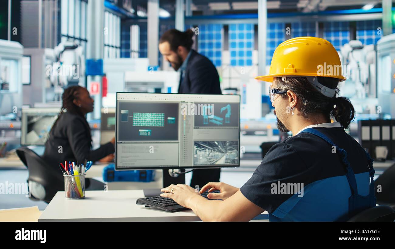 Photovoltaics factory specialist planning adjustments on facility floor ...