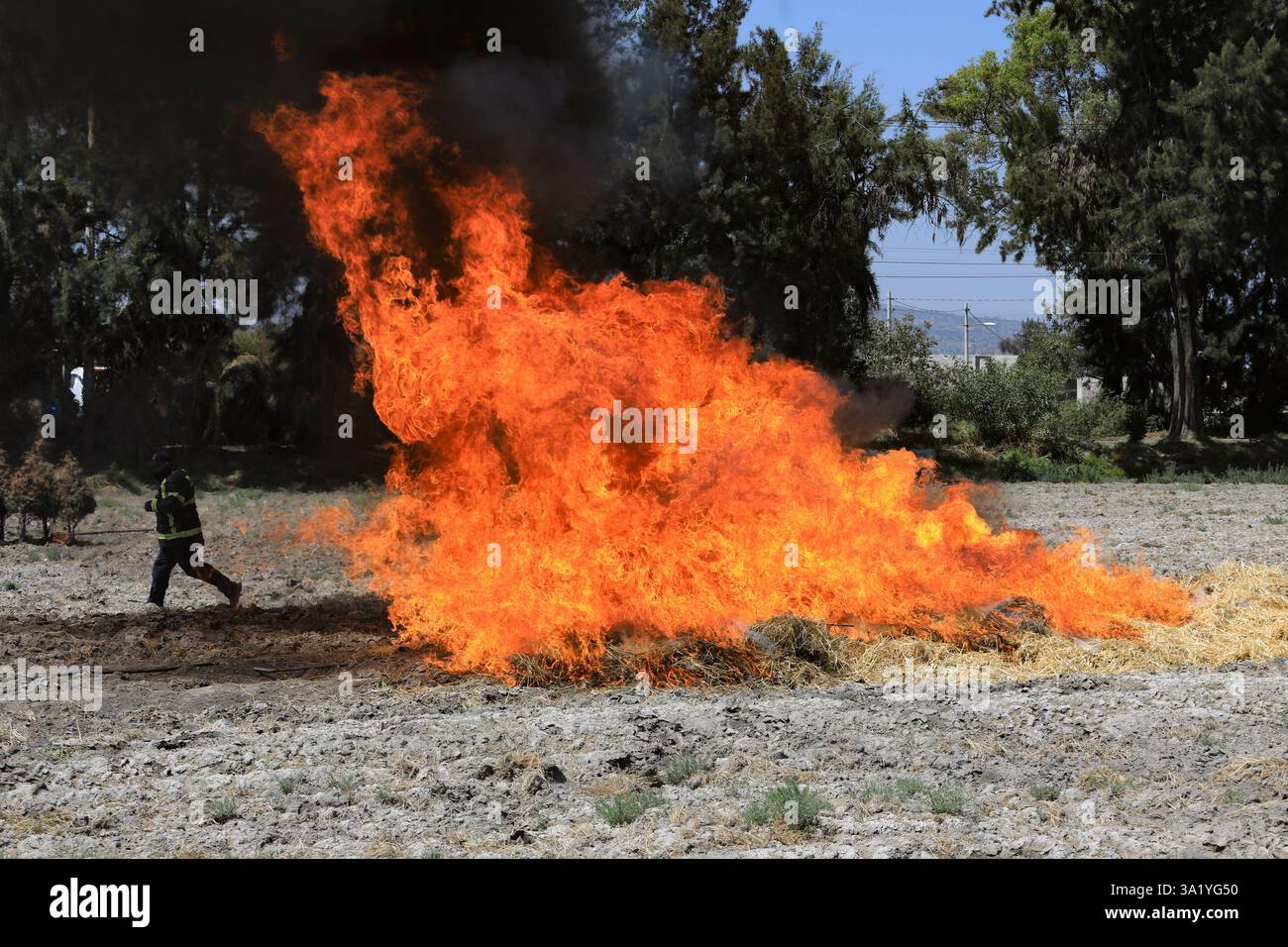 A member of the Mexico City Fire Department extinguishes a fire during ...