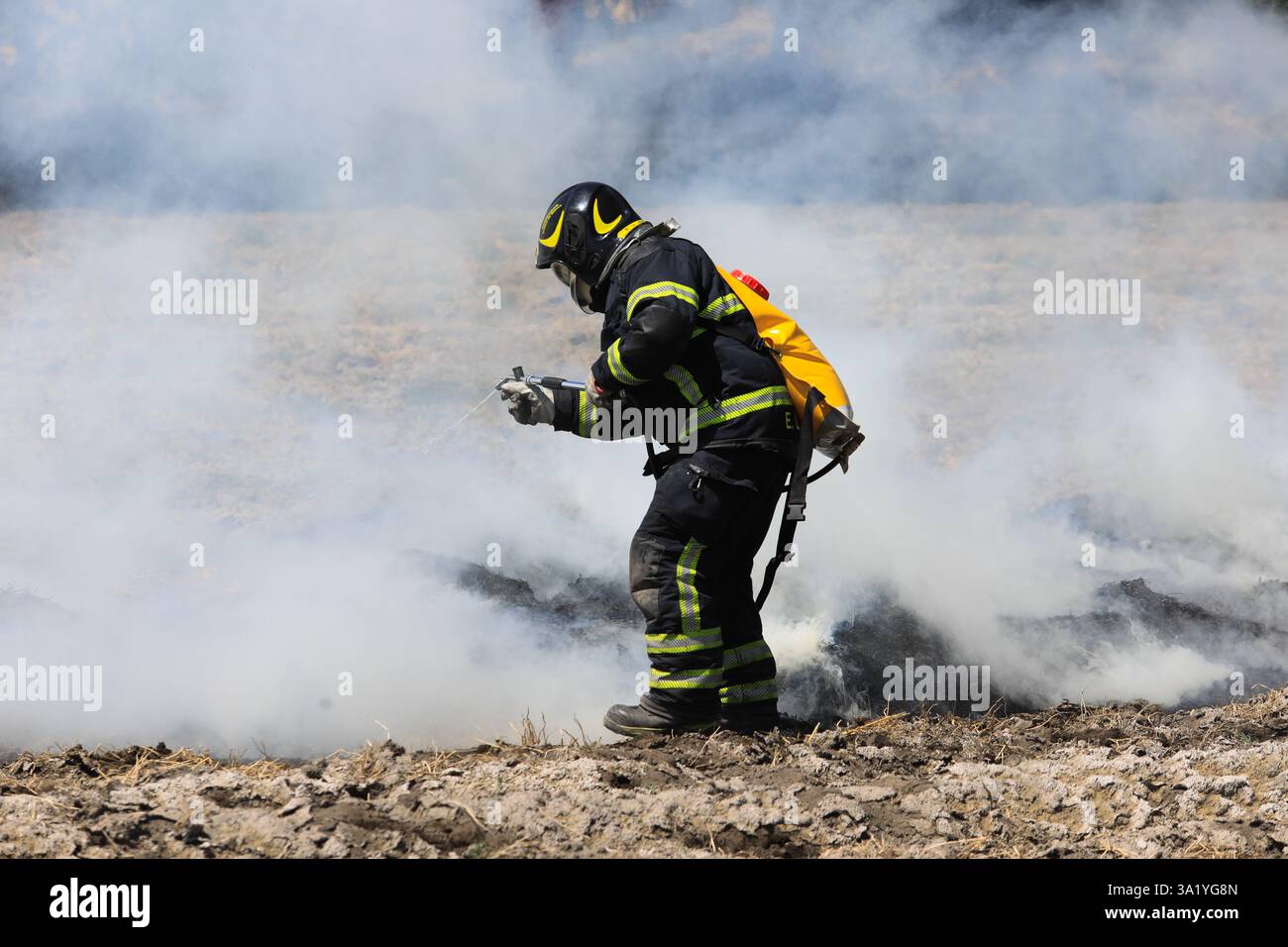 A member of the Mexico City Fire Department extinguishes a fire during ...