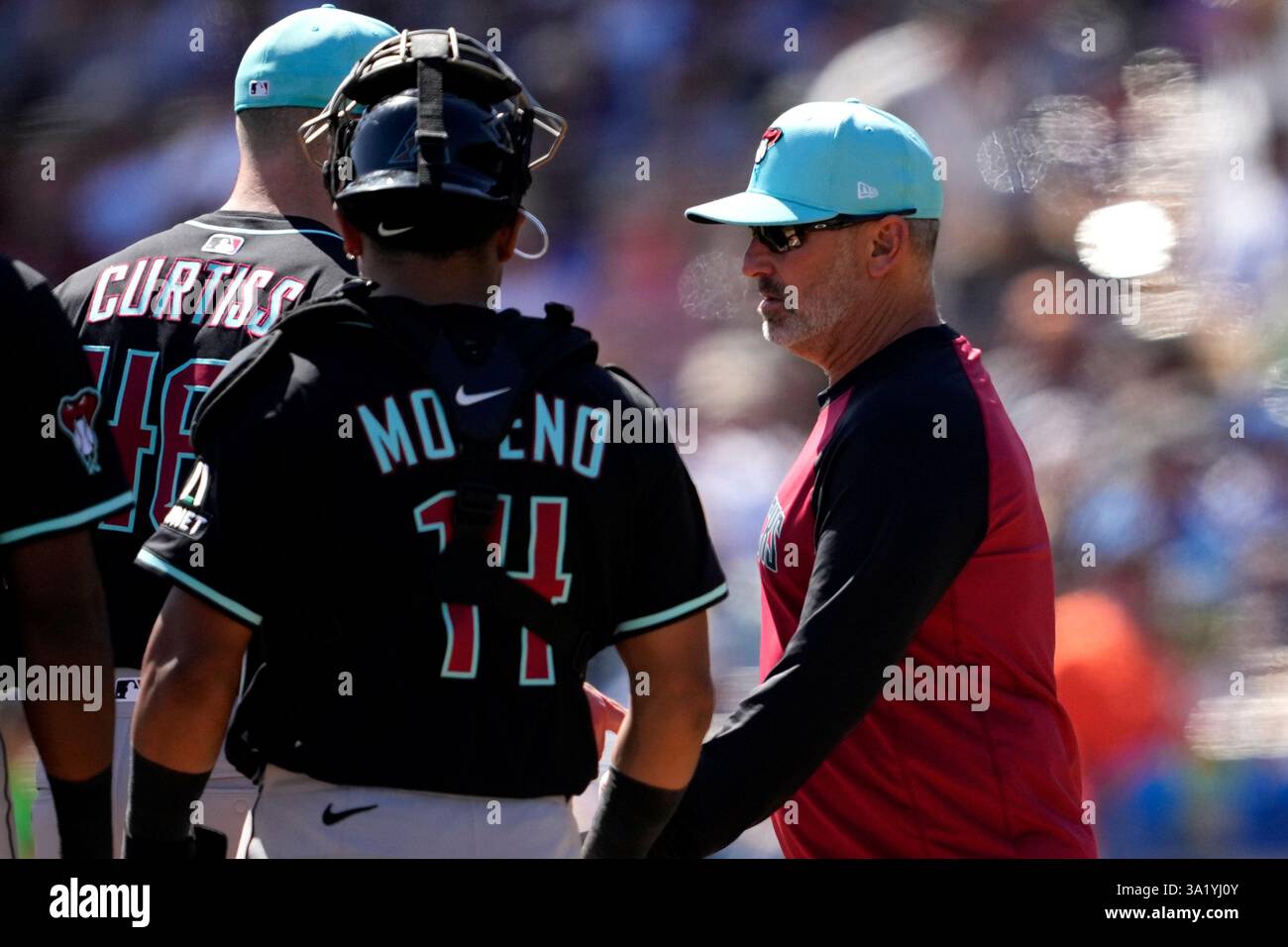 Arizona Diamondbacks manager Torey Lovullo, right, pulls pitcher John ...