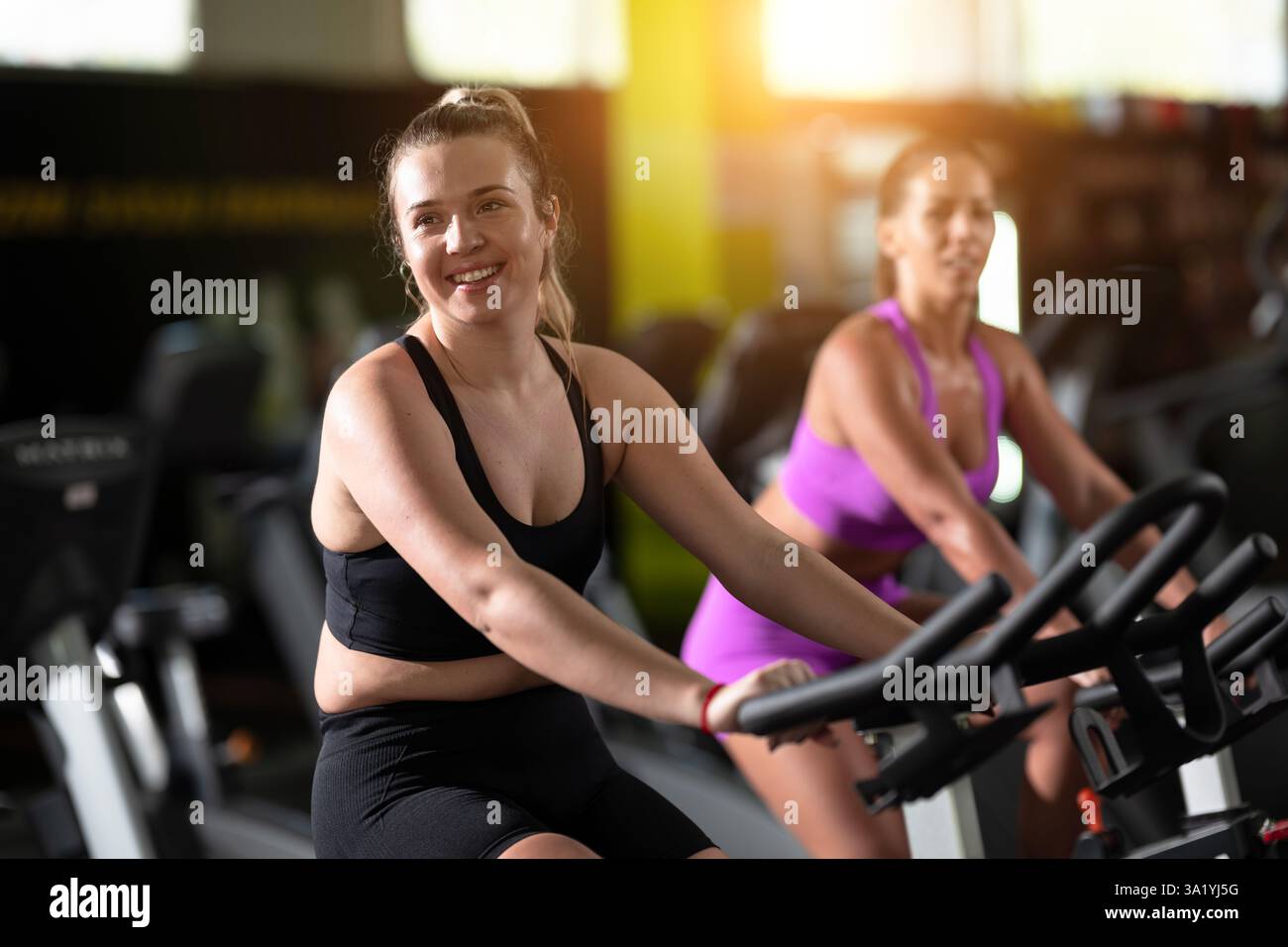Two fitness women working together on a conditioning workout in the gym ...