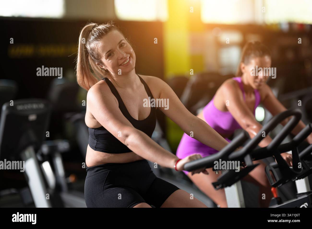 Two fitness women working together on a conditioning workout in the gym ...