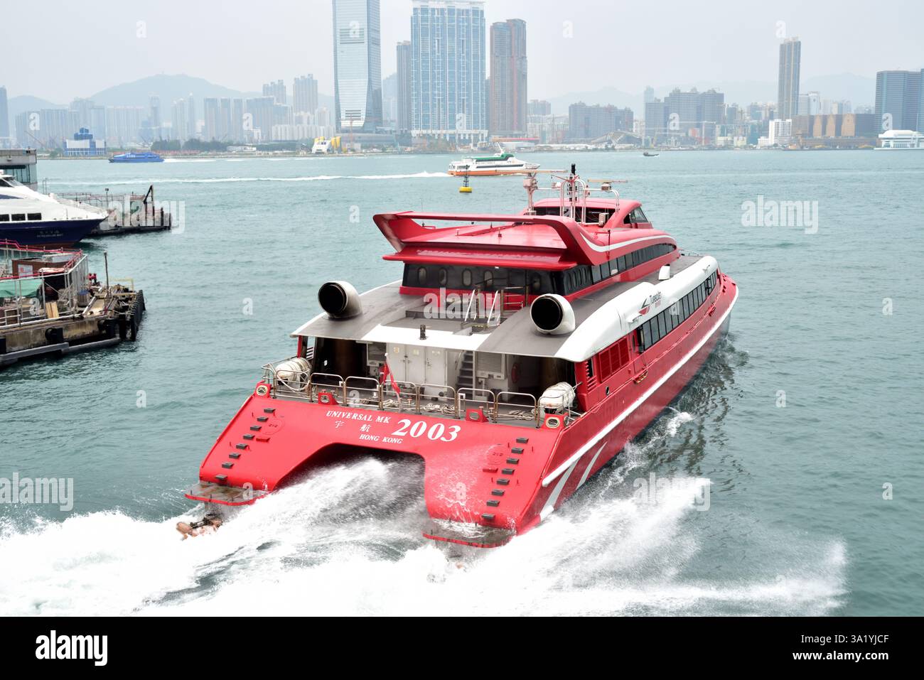 Turbojet catamaran departing from Hong Kong Sheung Wan pier to Macau ...