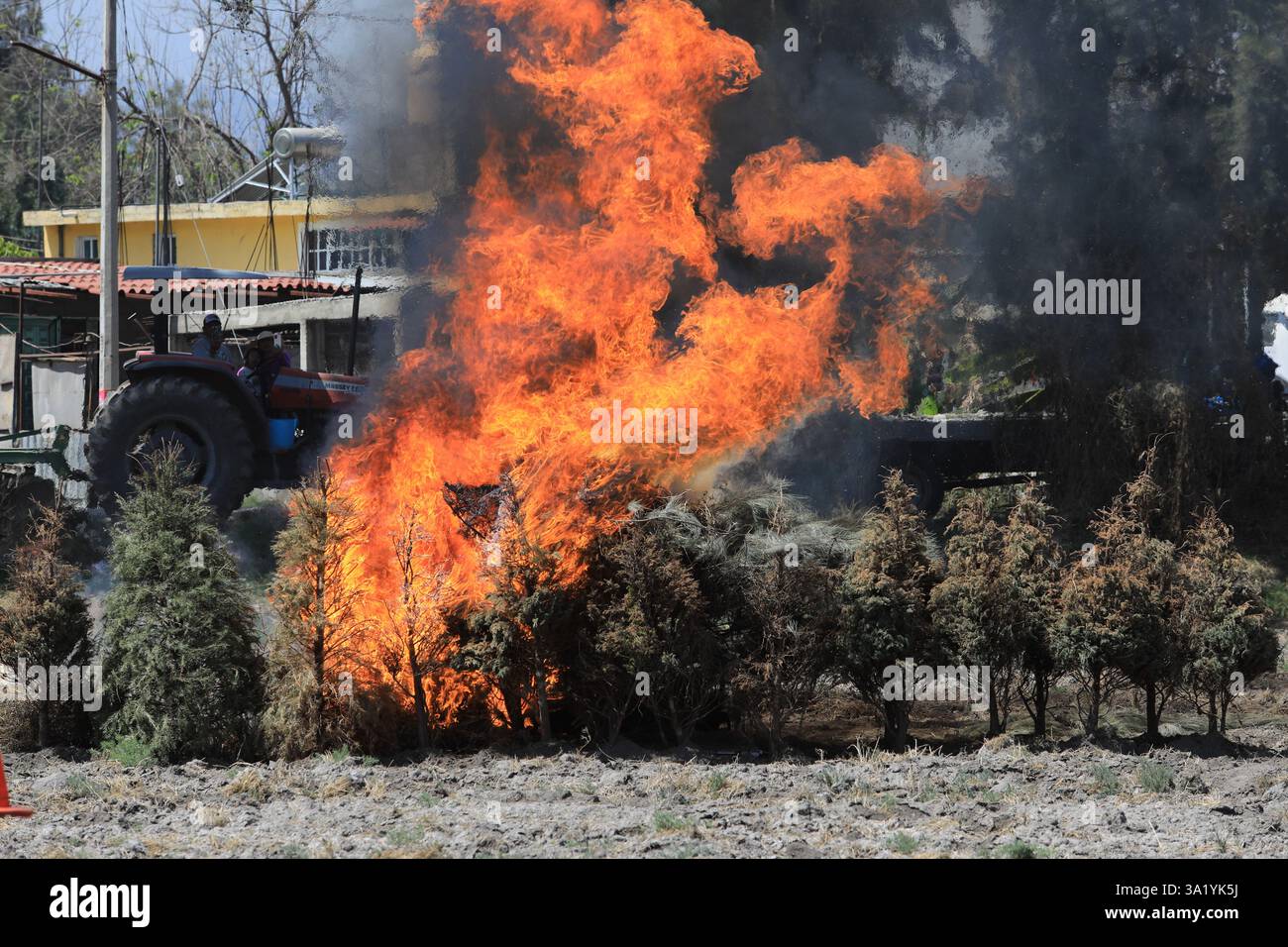 A member of the Mexico City Fire Department extinguishes a fire during ...