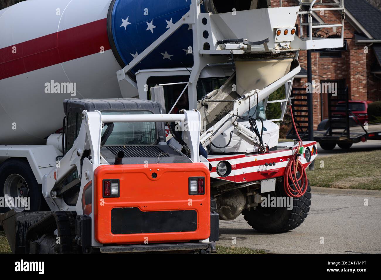 Loading concrete from mixer truck to front loader vehicle Stock Photo ...