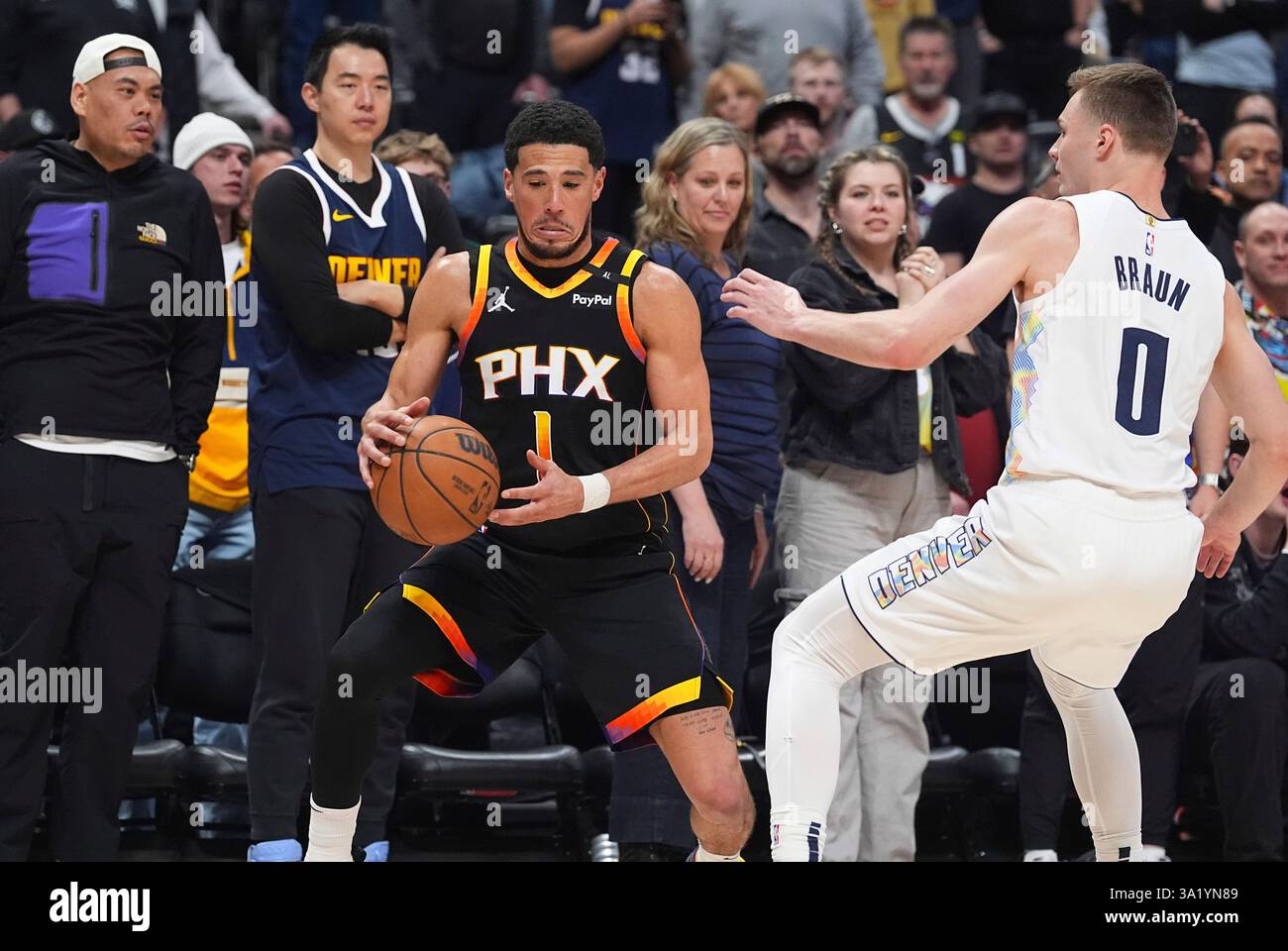 Phoenix Suns guard Devin Booker (1) and Denver Nuggets guard Christian ...