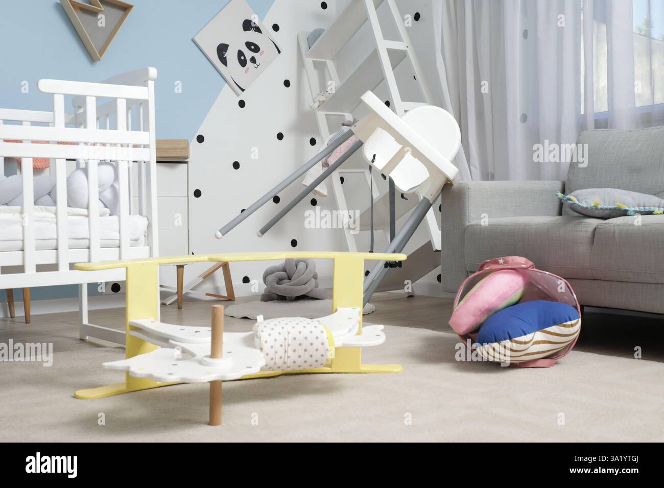Interior of messy children's room with overturned furniture after ...