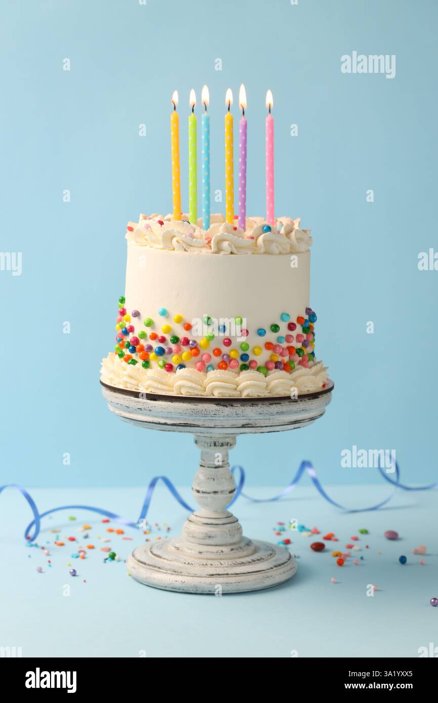 Delicious bento cake with colorful sprinkles, burning candles and ...