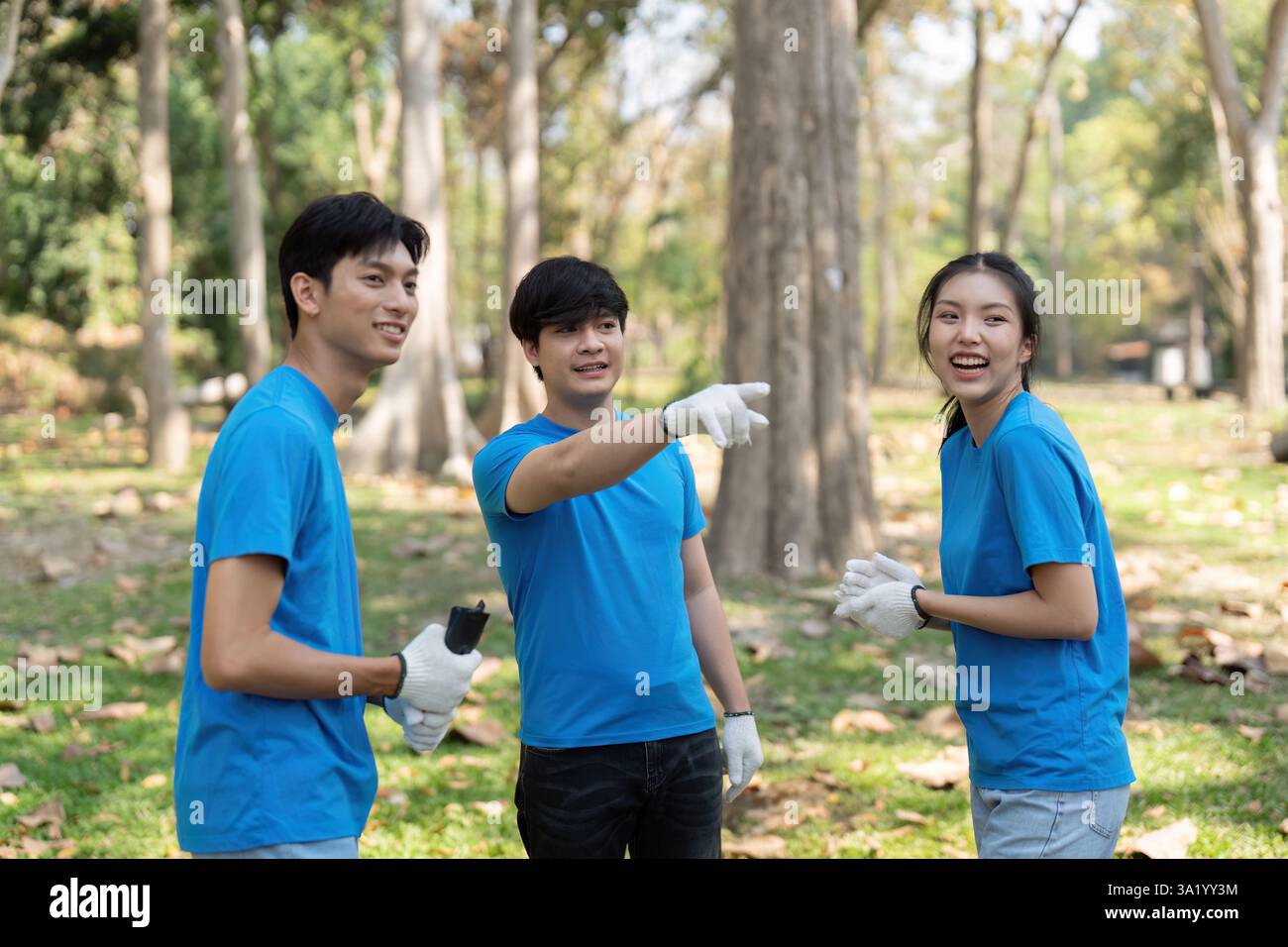 Volunteers enjoying their time while cleaning a park, fostering ...