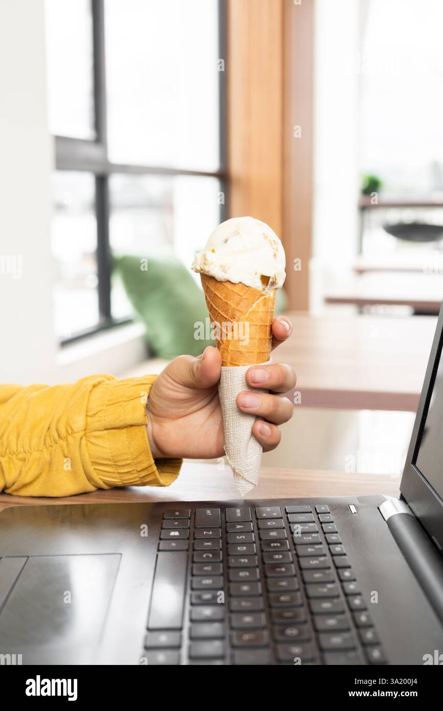 A professional office worker holding an ice cream cone with a scoop ...