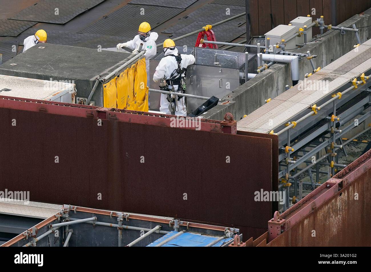 Workers in hazmat suits are seen at the Fukushima Daiichi nuclear power ...