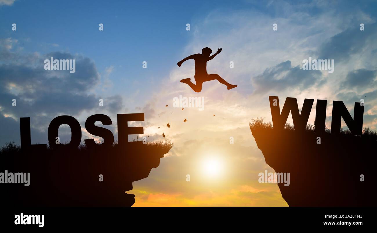 Silhouette man jumping from LOSE to WIN wording on cliffs with cloud ...