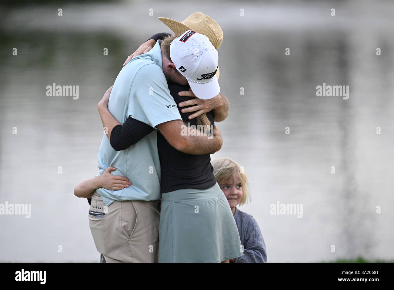 Russell Henley, left, hugs his wife Teil Henley on the 18th green after ...