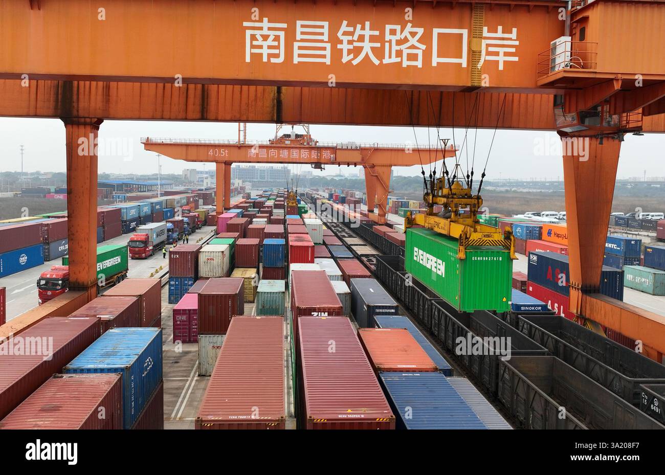 NANCHANG, CHINA - MARCH 6, 2025 - A gantry crane lifts containers ...
