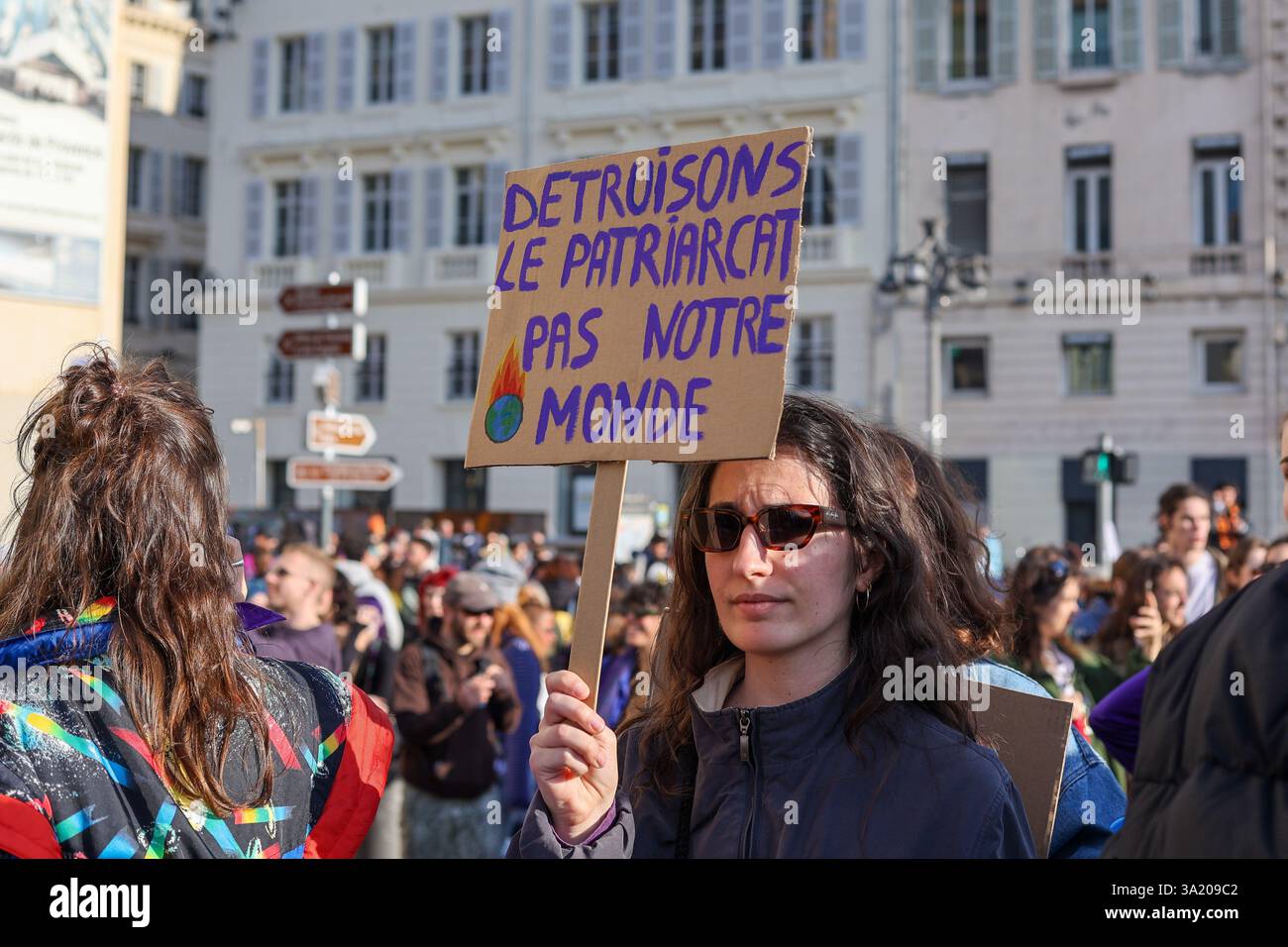 Marseille, France. 08th Mar, 2025. A woman holds a placard that says ...