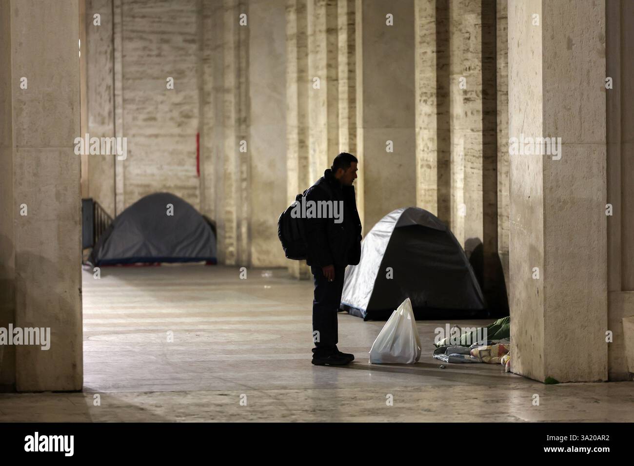 Vatican City, Italy. 08th Mar, 2025. A volunteer approaches a homeless ...