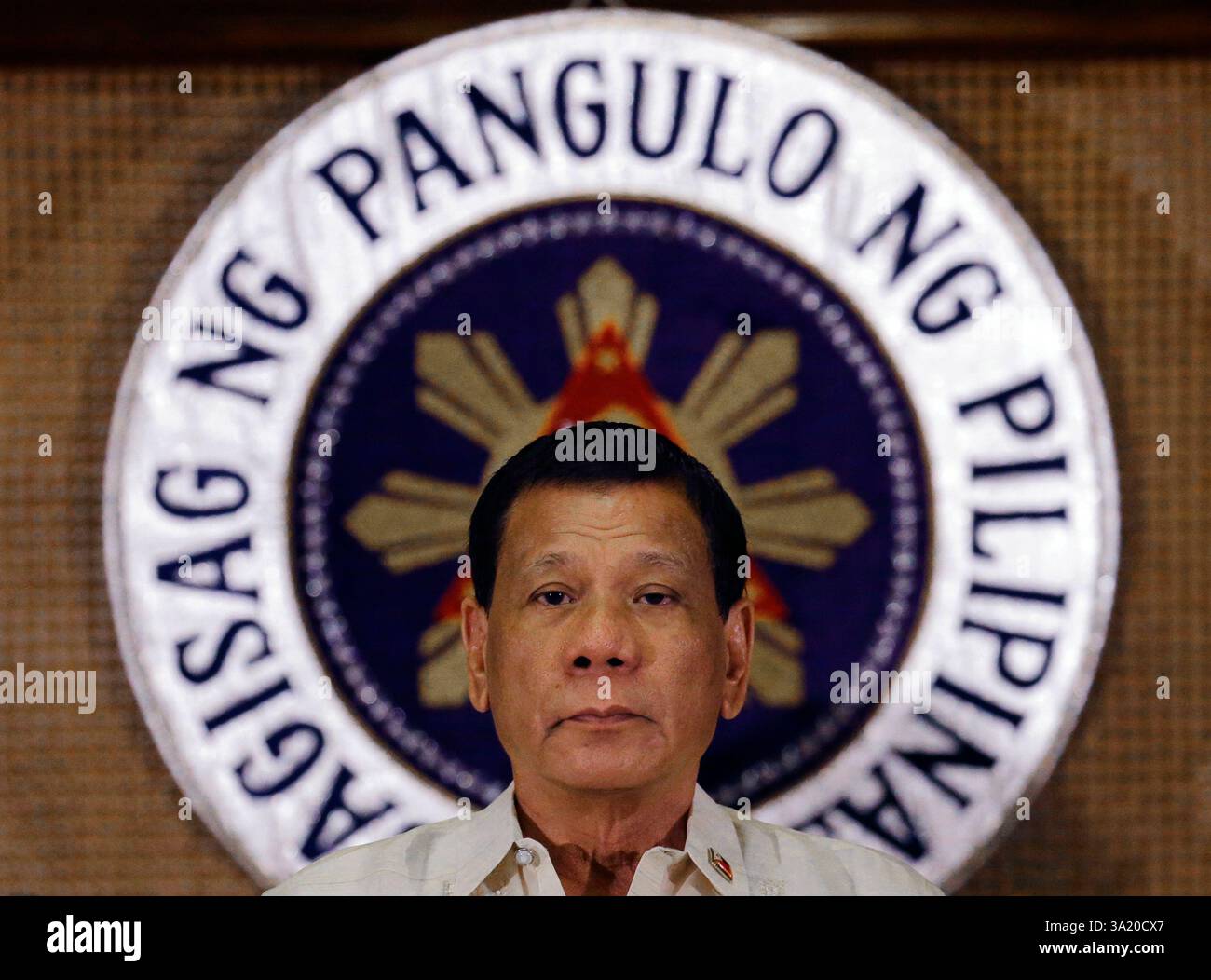 FILE - Philippine President Rodrigo Duterte stands in front of the ...
