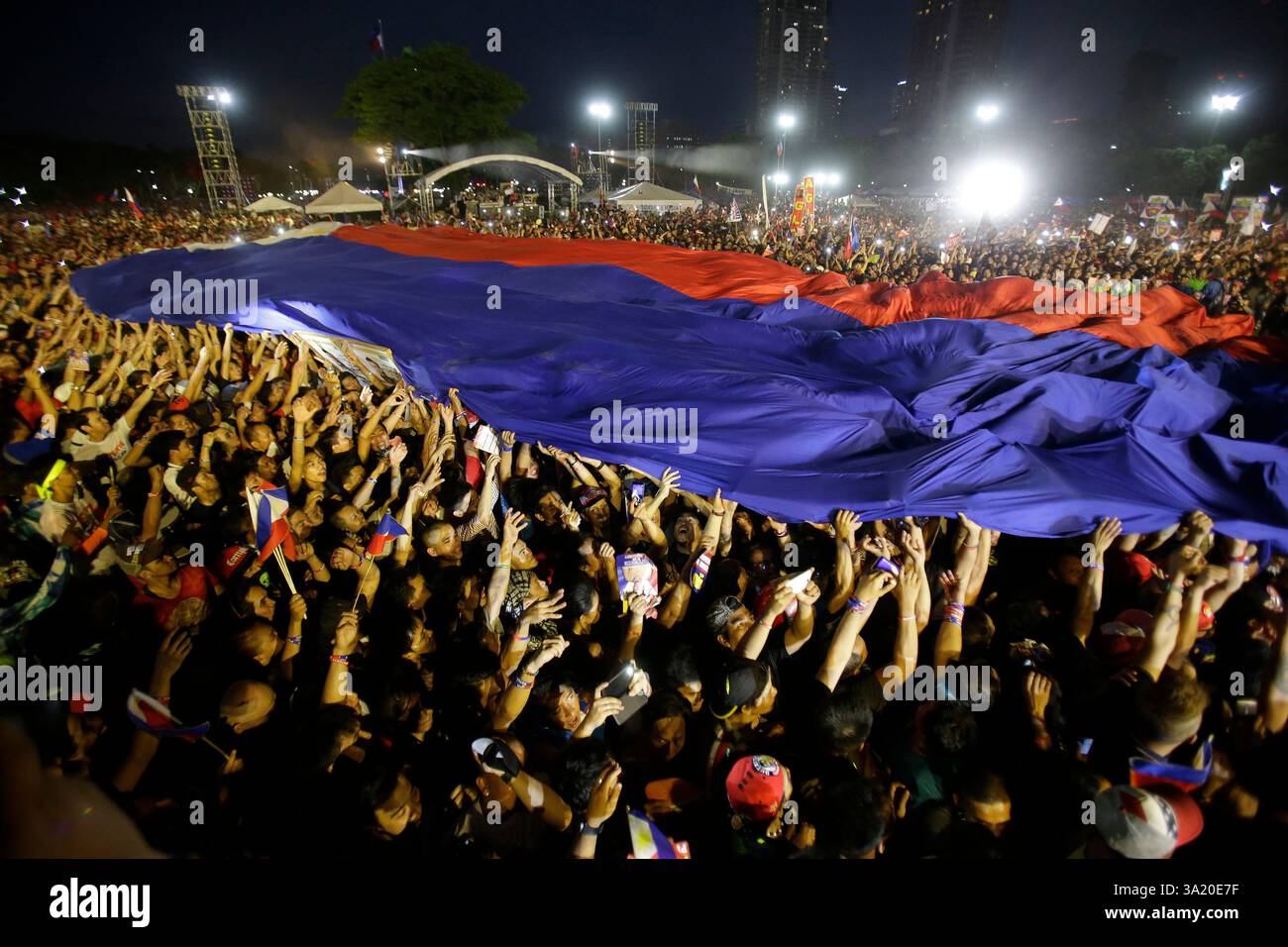 FILE- Supporters pass around the Philippine flag during the final ...