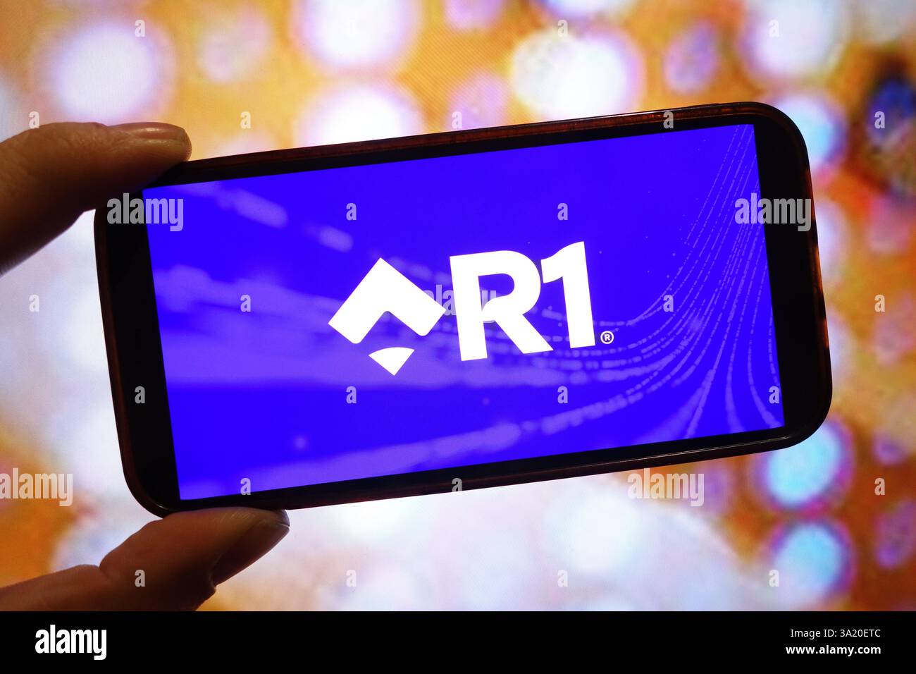 In this photo illustration, the R1 RCM company logo is seen displayed ...