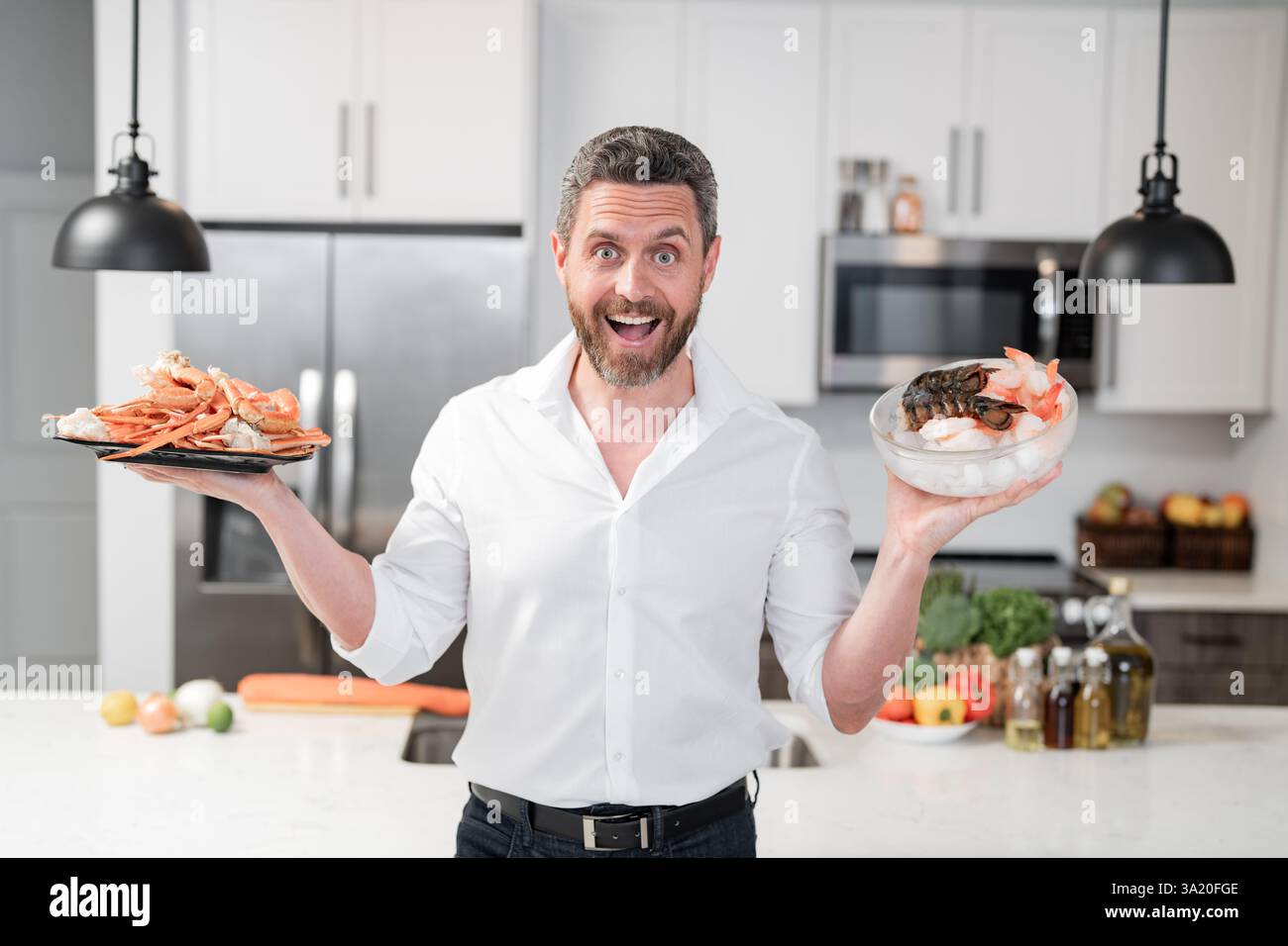 Chef man cooking seafood crab and shrimp, salmon and lobster in kitchen ...