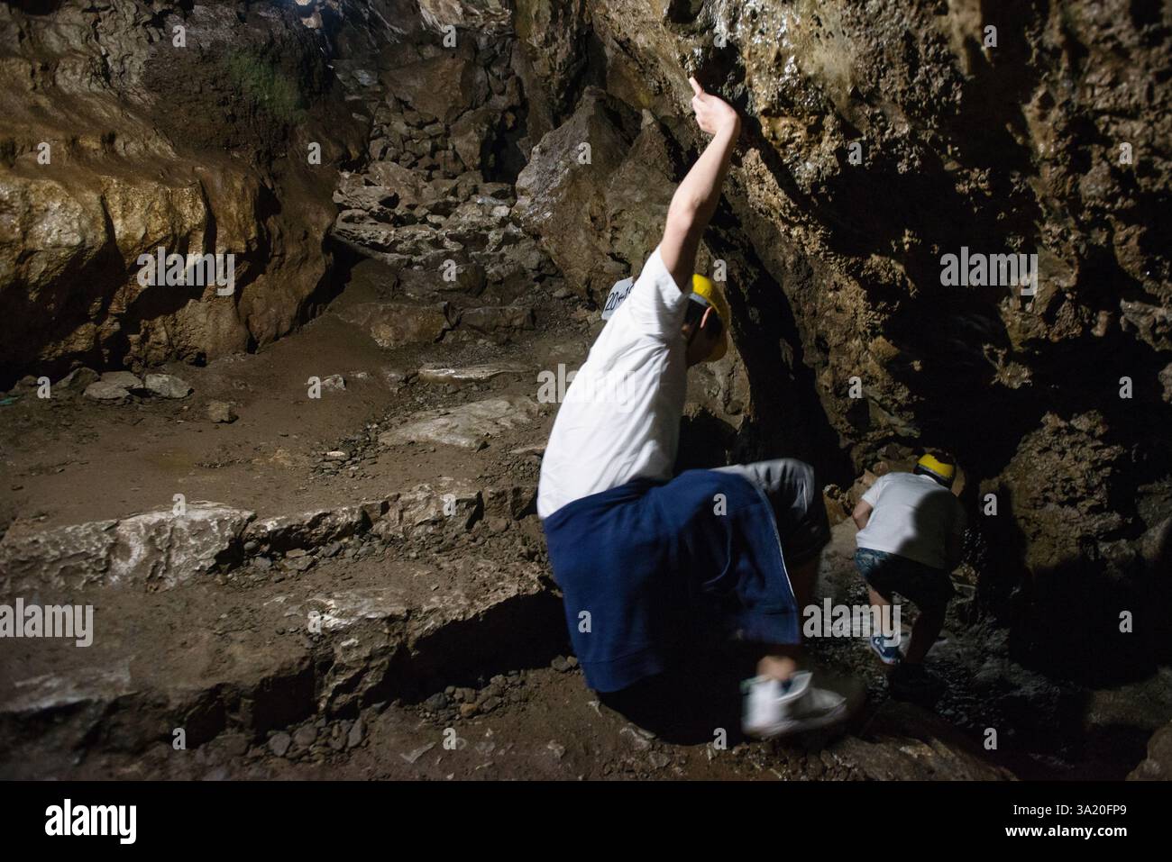VISITORS MAKE THEIR WAY AROUND THE OTAKE CAVES IN OKUTAMA DISTRICT OF ...