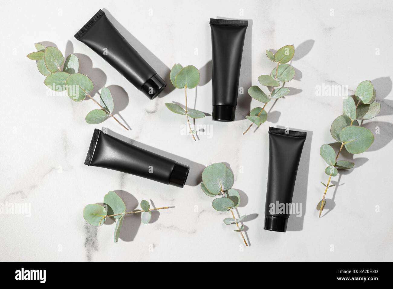 Top view of a black cosmetic tubes with sleek designs, positioned on a ...