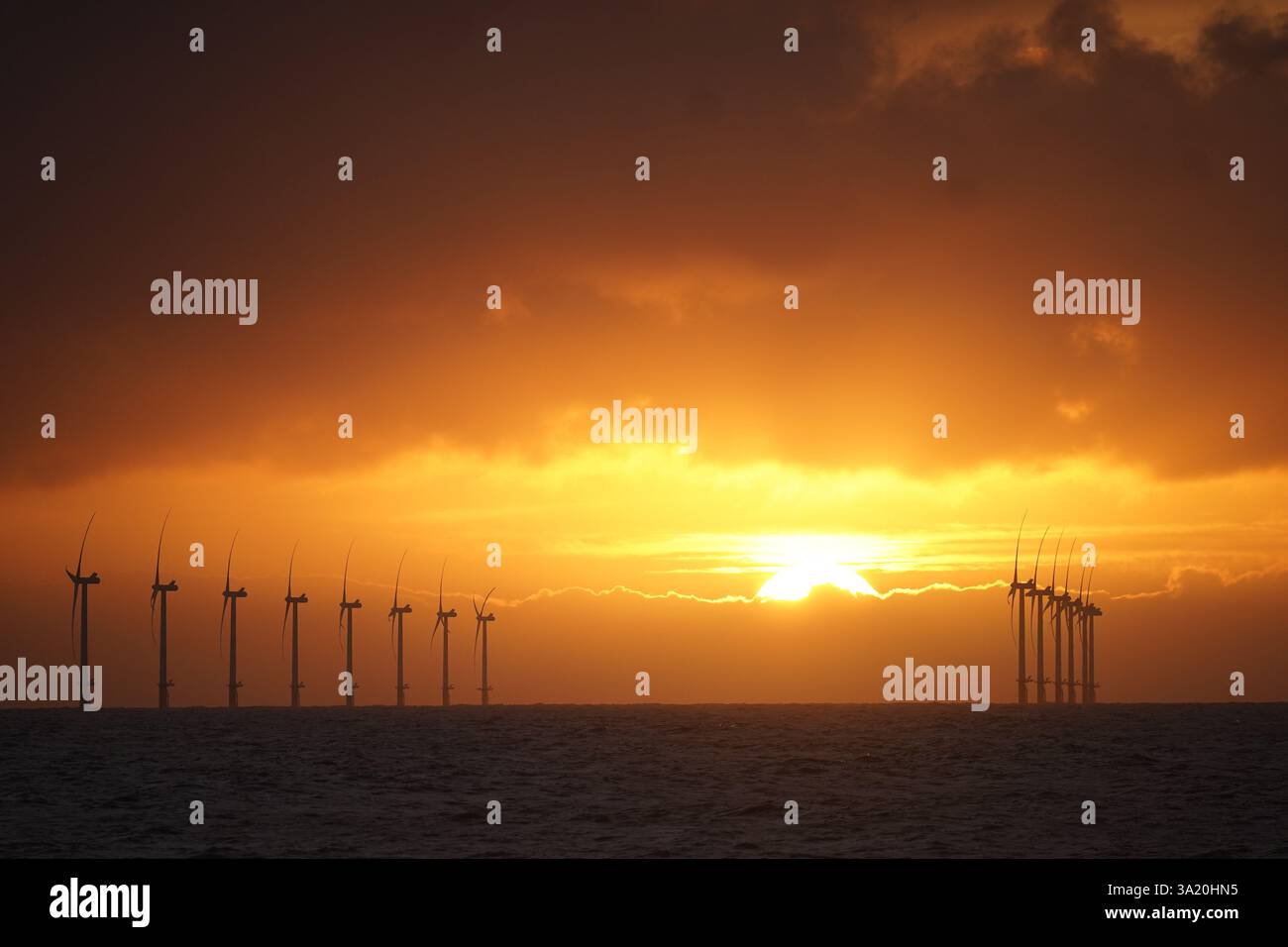 Sunrise behind a windfarm near Easington beach, Hull, after a crash ...