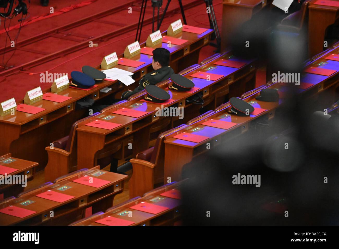 Peking, China. 11th Mar, 2025. A delegate sits alone in the plenary ...