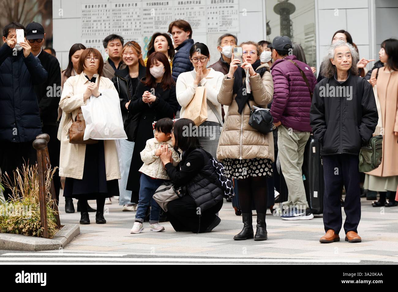 Tokyo, Japan. 11th Mar, 2025. People pray during a moment of silence at ...