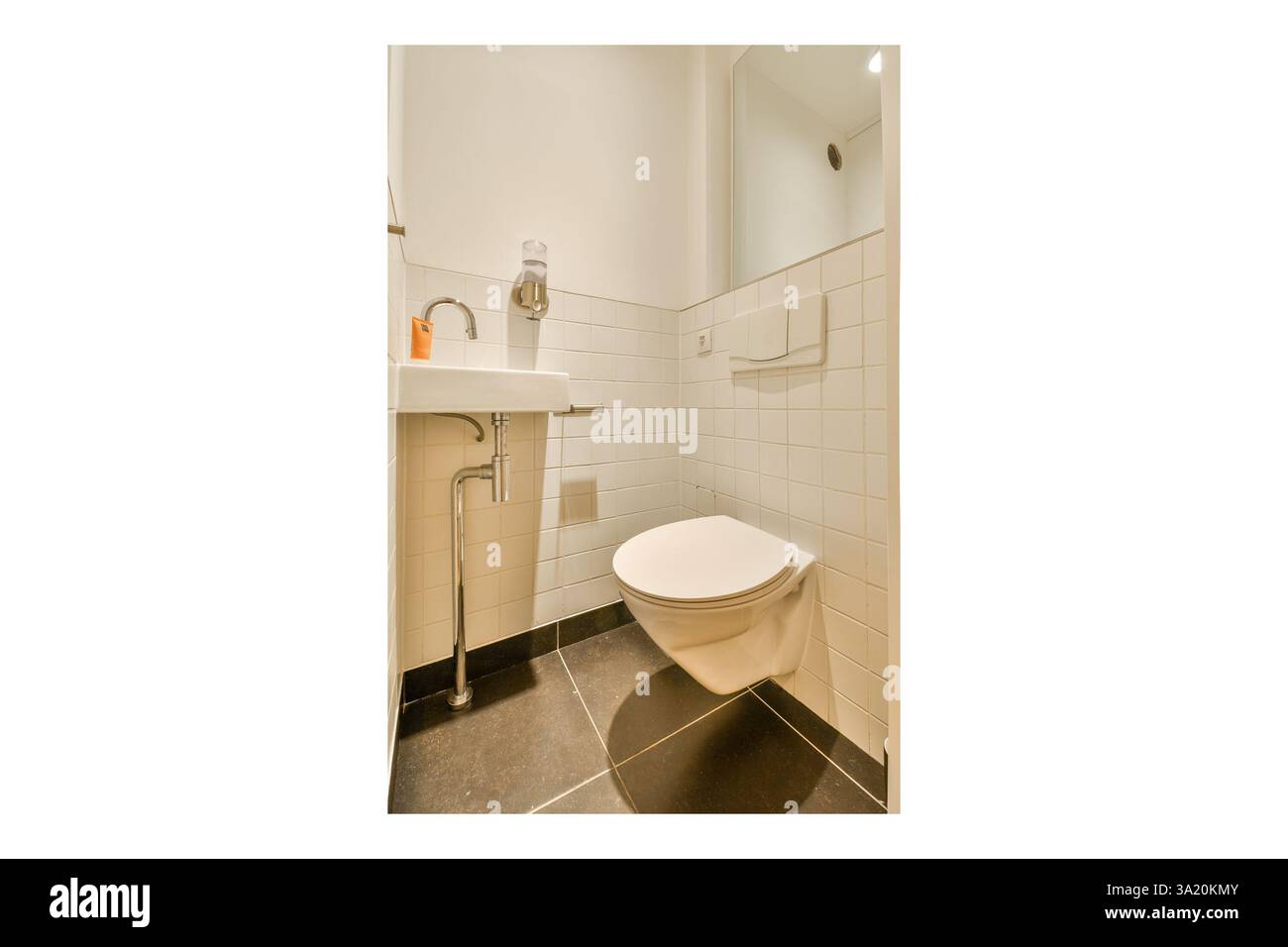 A sleek and contemporary bathroom featuring a wall-mounted sink and a ...