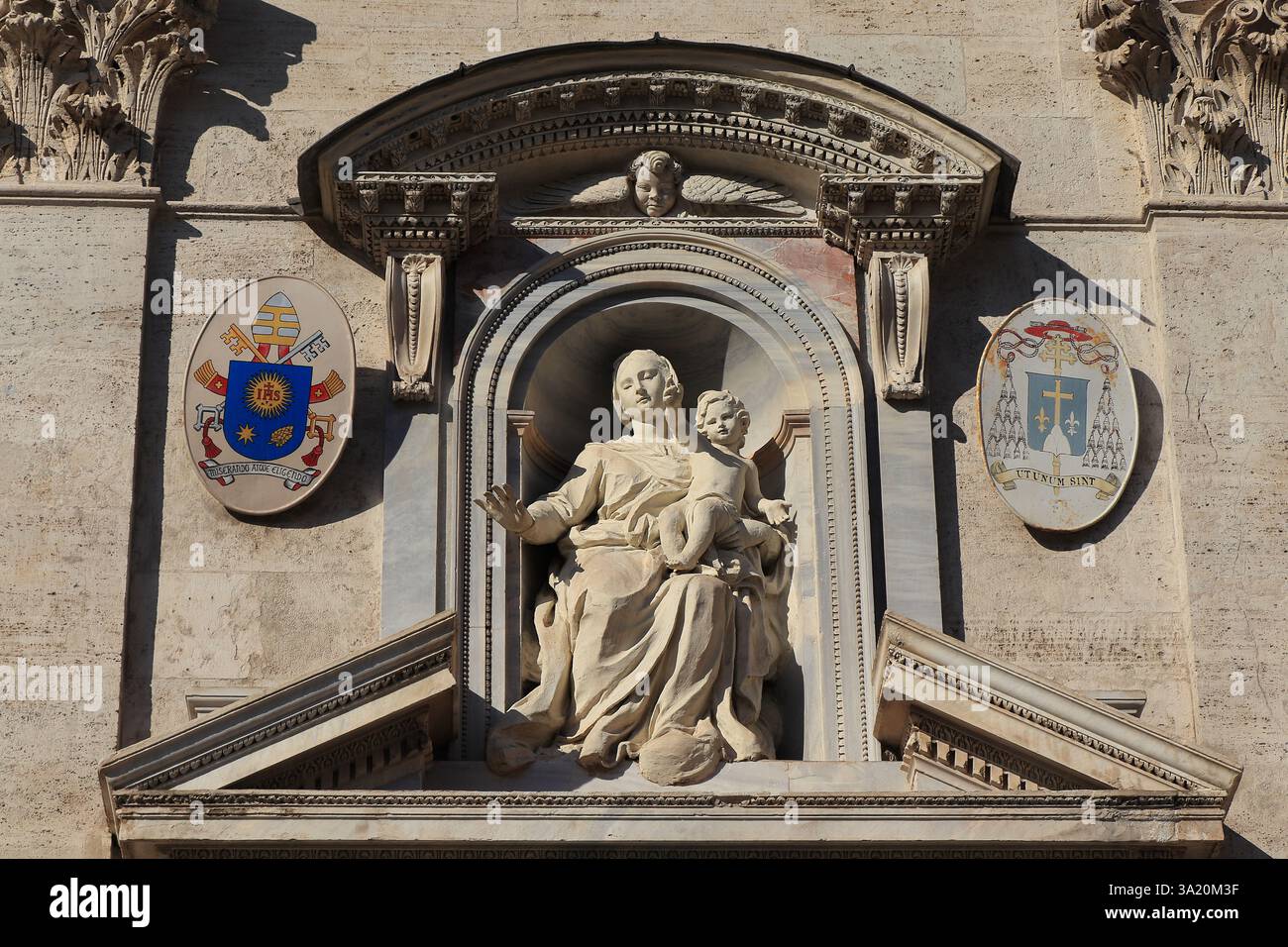Madonna with child statue in a niche on the facade of Santa Maria in ...