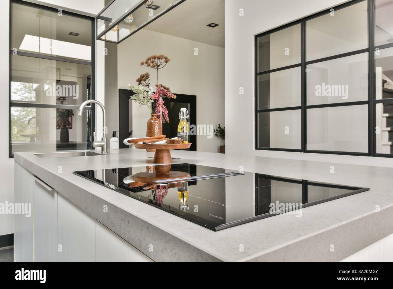 A stylish modern kitchen featuring a minimalist design with a centrally ...