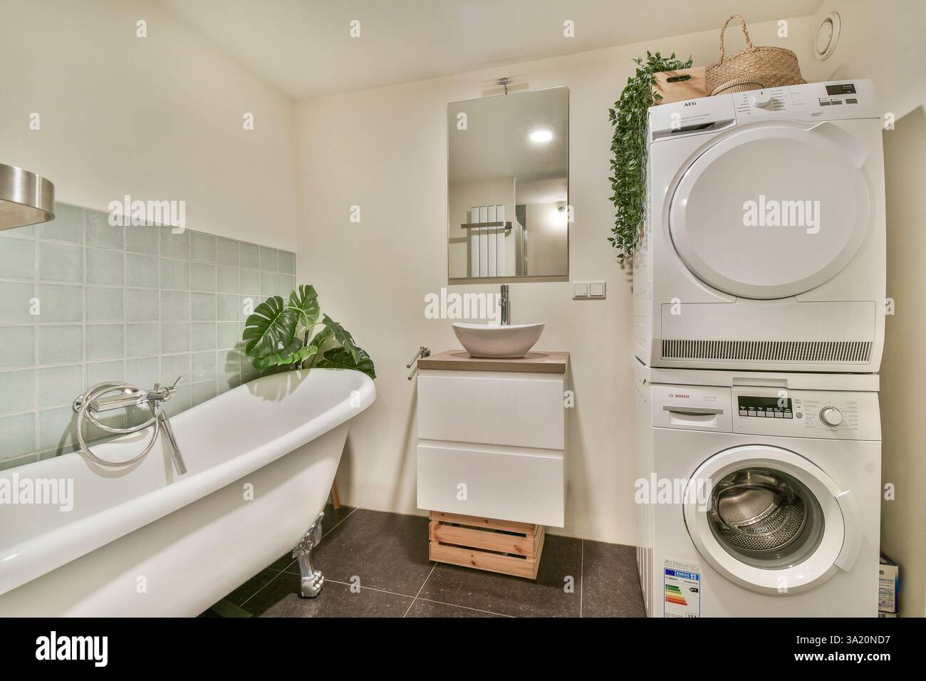 A stylish bathroom featuring a contemporary bathtub and a compact ...