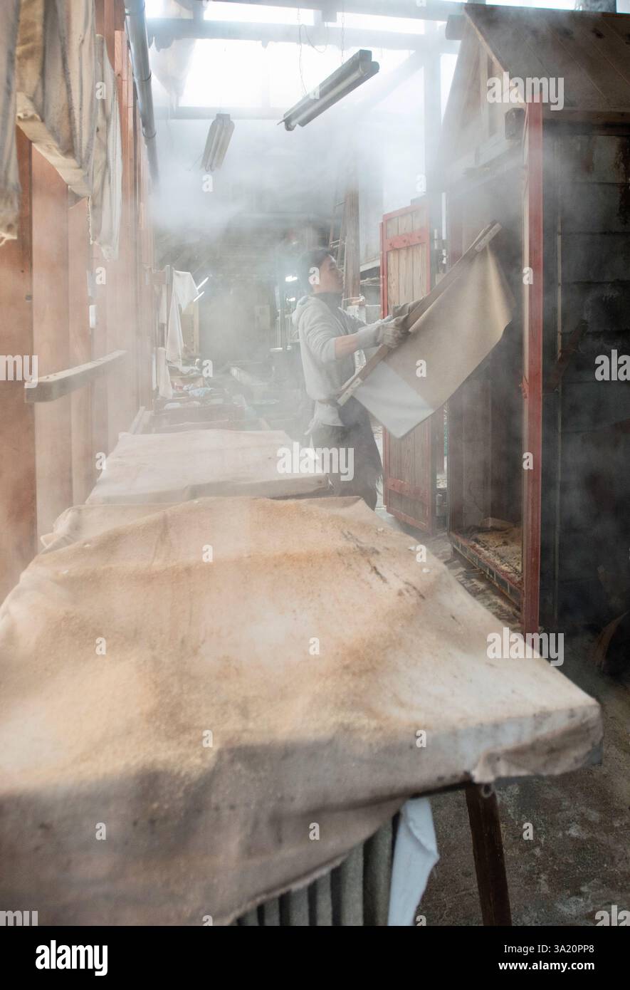 Artisans produce colored dyes and steam and wash fabrics using the ...