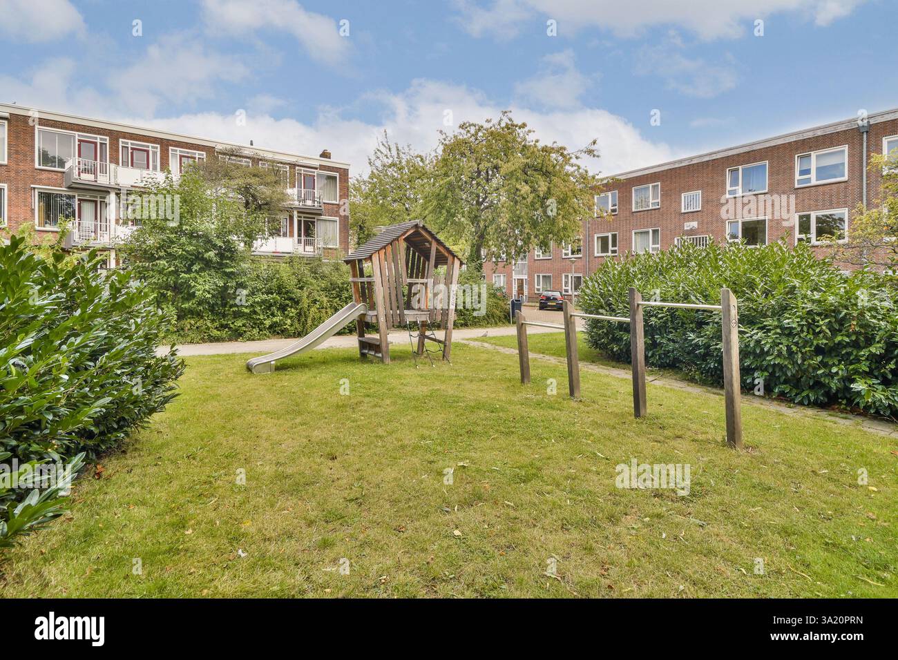 A serene playground surrounded by greenery in a residential ...